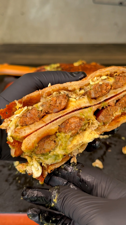Man grills chorizo breakfast sandwiches