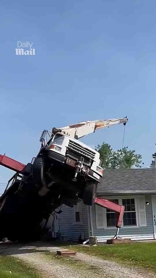 Crane crashes onto Indiana home during tree removal disaster