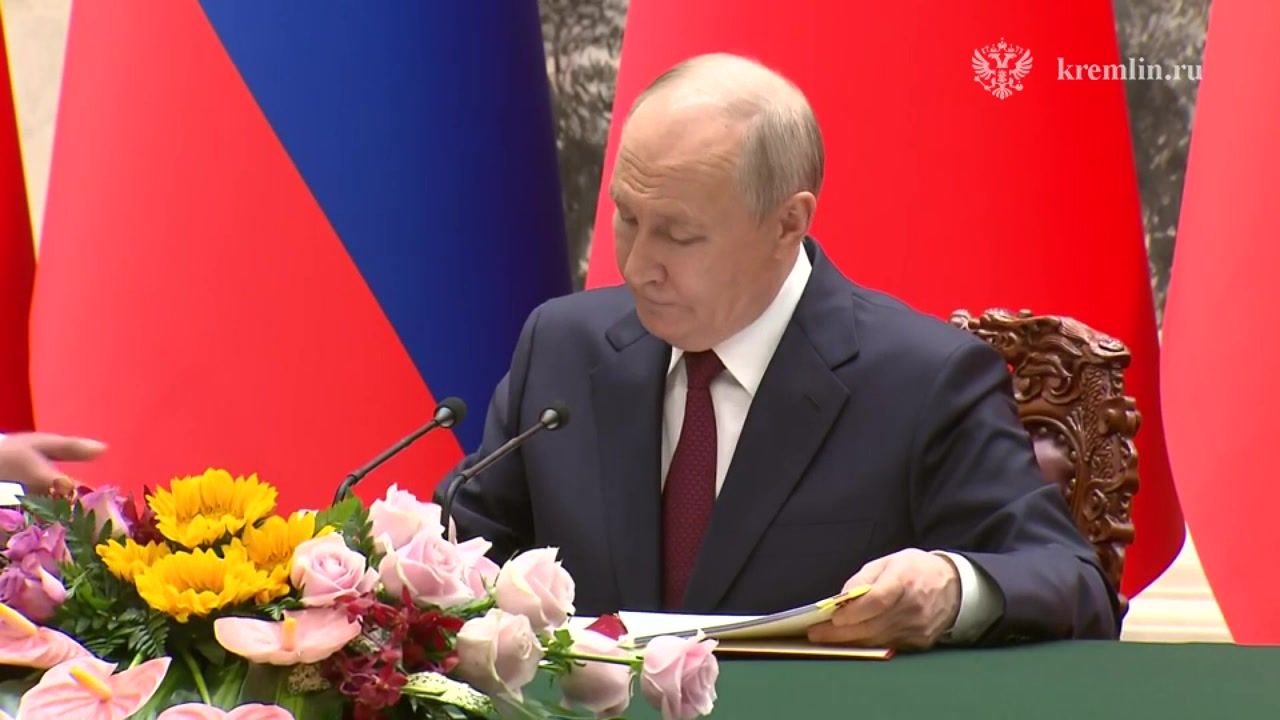 Putin accused of using 'exoskeleton' after awkward walk in China