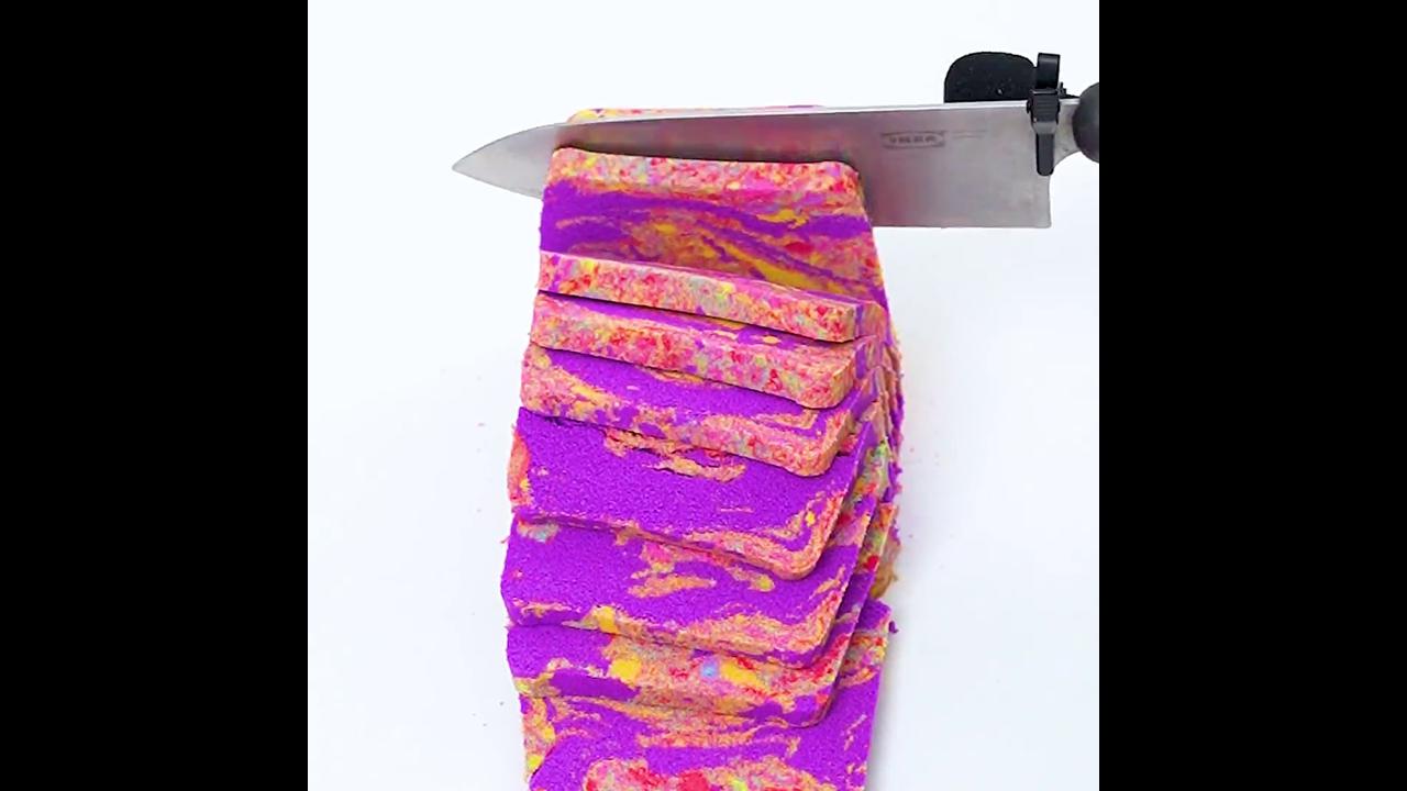 Satisfying slicing mixed pink sand block with knife creating vibrant ...