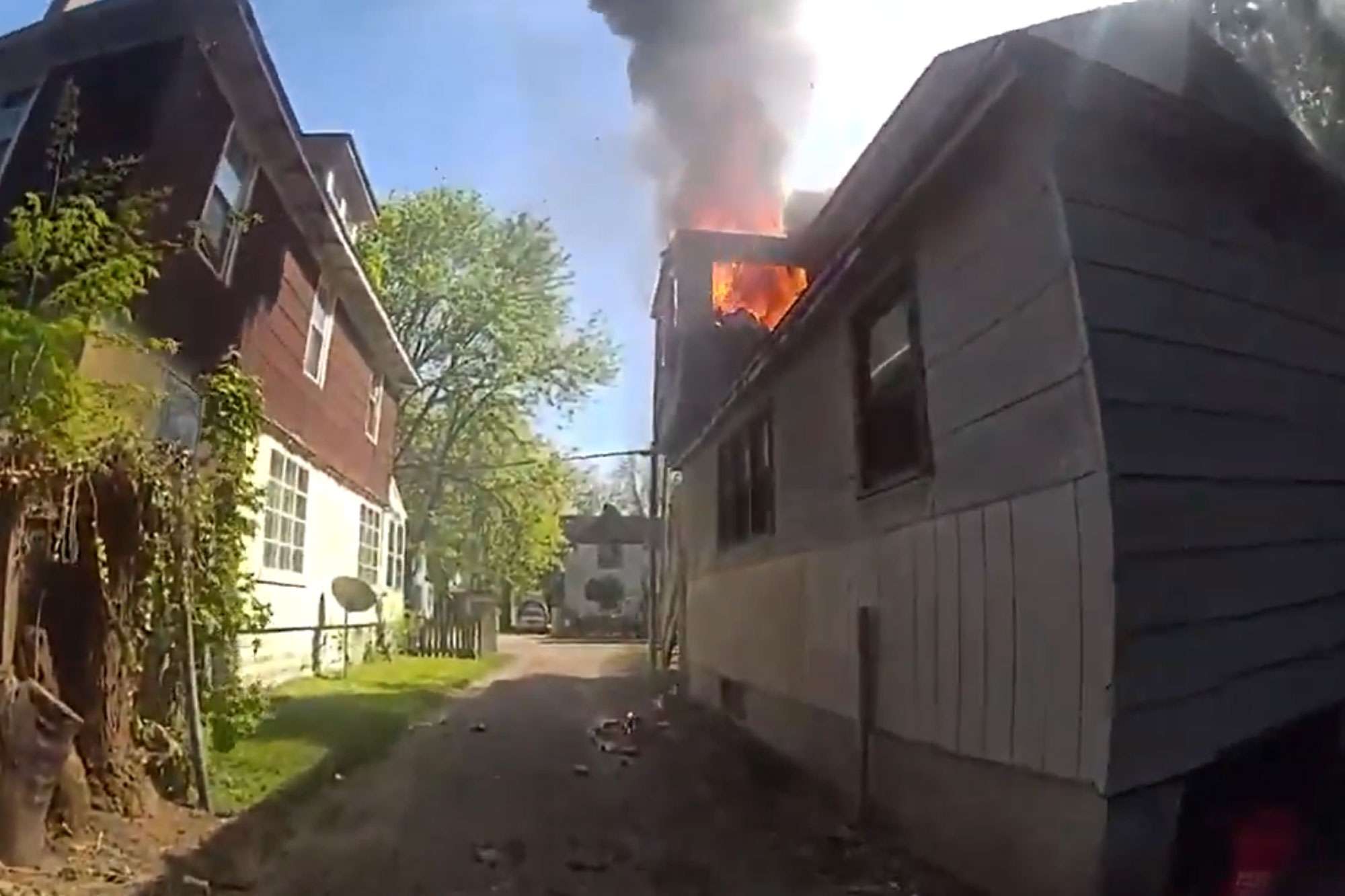 Officer catches baby from window of burning home after urging trapped ...