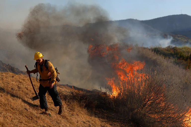 Sandy fire in photos: A fierce firefight as thousands flee the flames