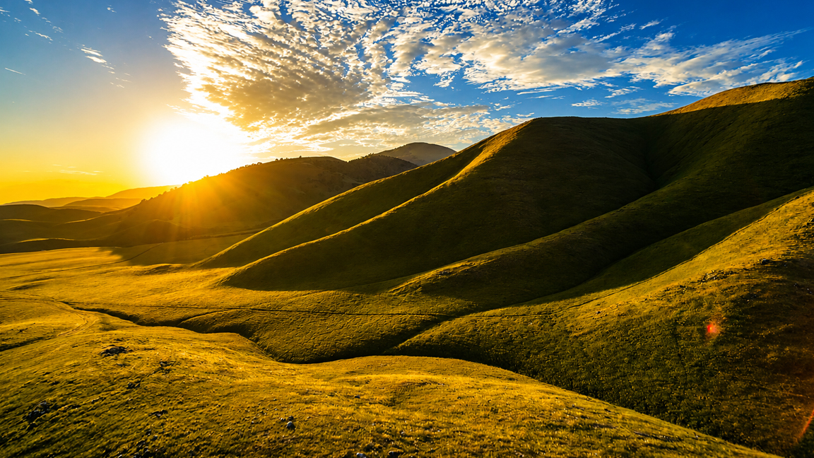 Golden sunset over rolling hills and scenic landscape