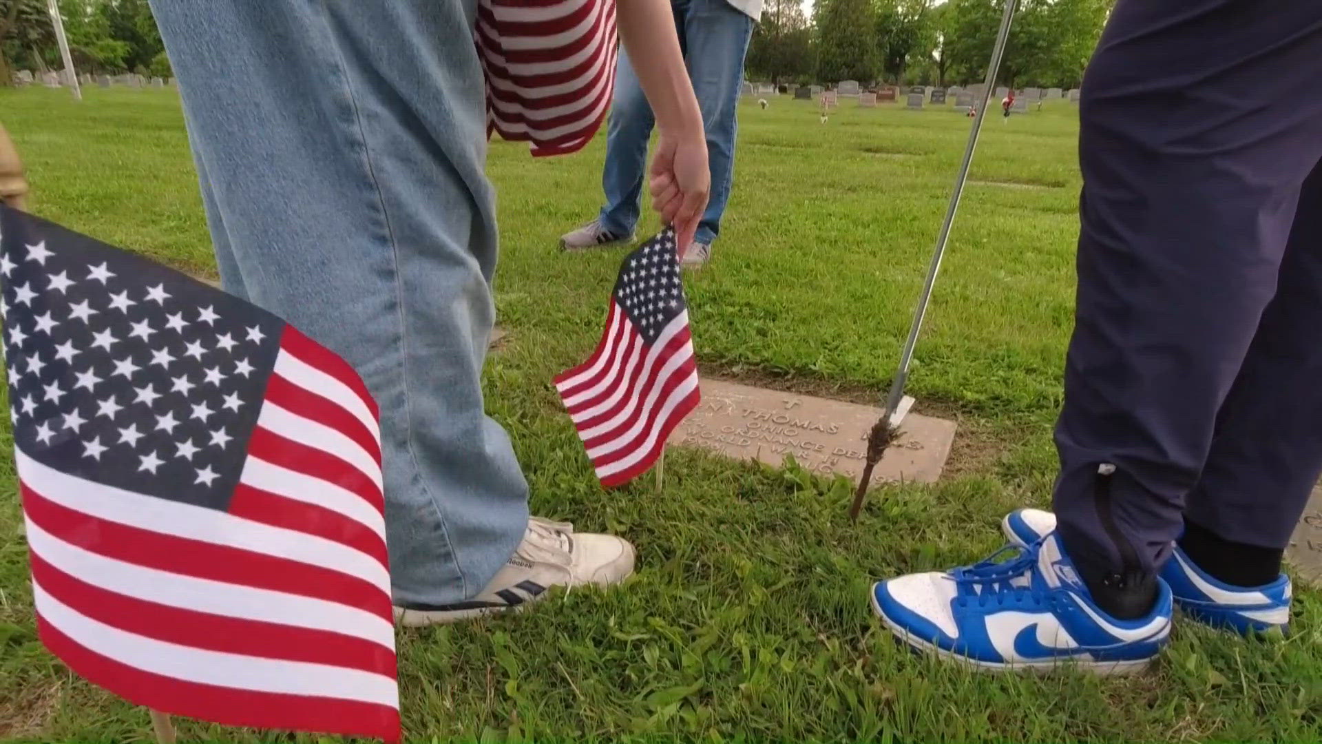 Scouts step up to place flags on graves before Memorial Day