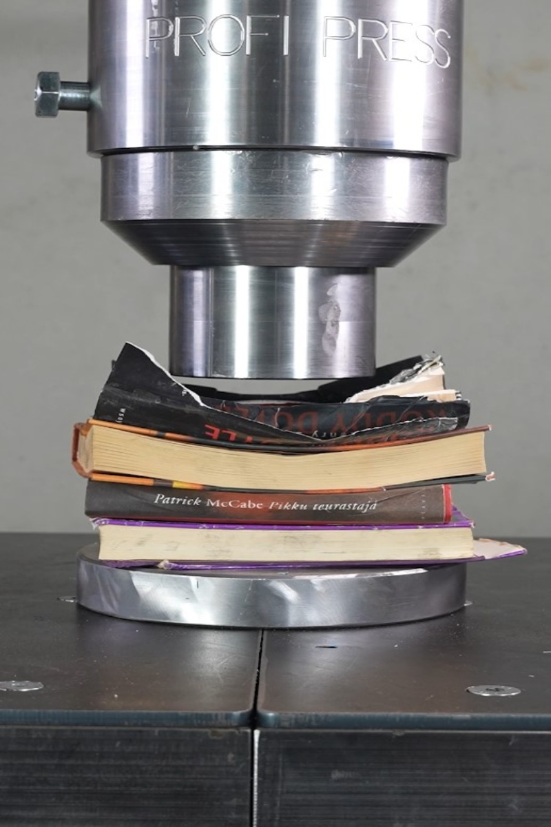 Crushing books under a hydraulic press