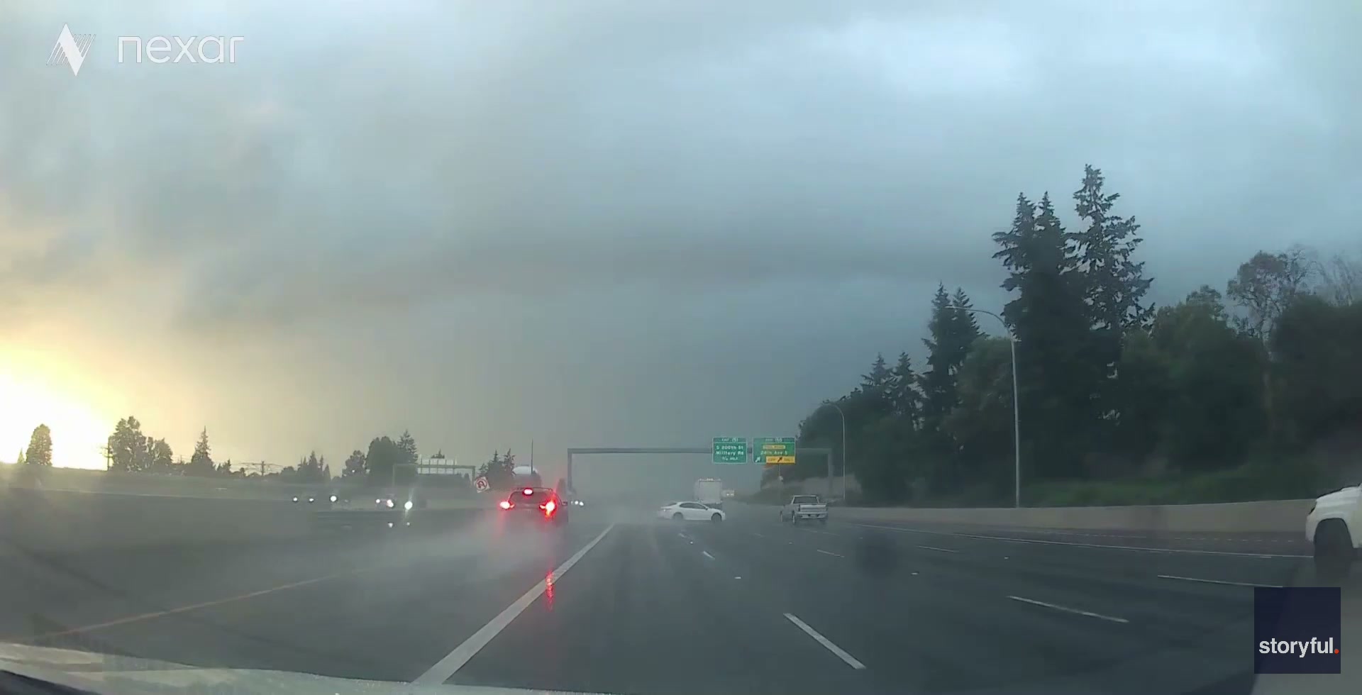 Frightening moment car swerves over several lanes, hits truck amid wet ...