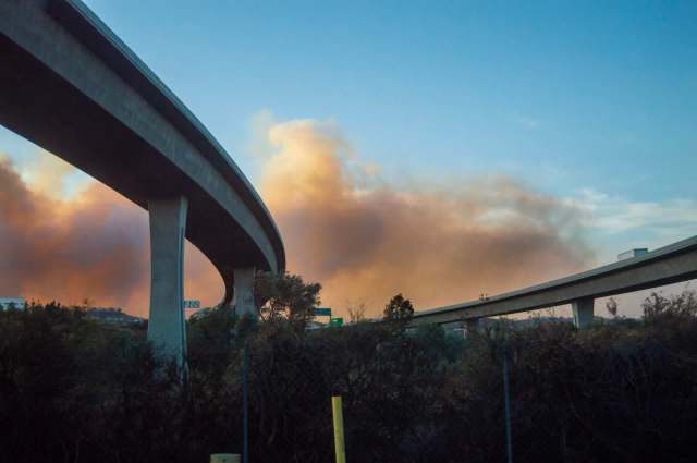 Tens of thousands evacuated as California brush fire races toward homes ...
