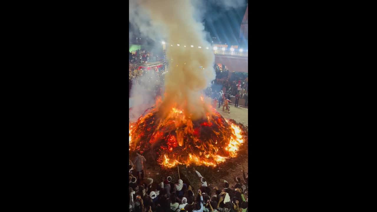 Man walking barefoot through fire at Holika Dahan in India captured in ...