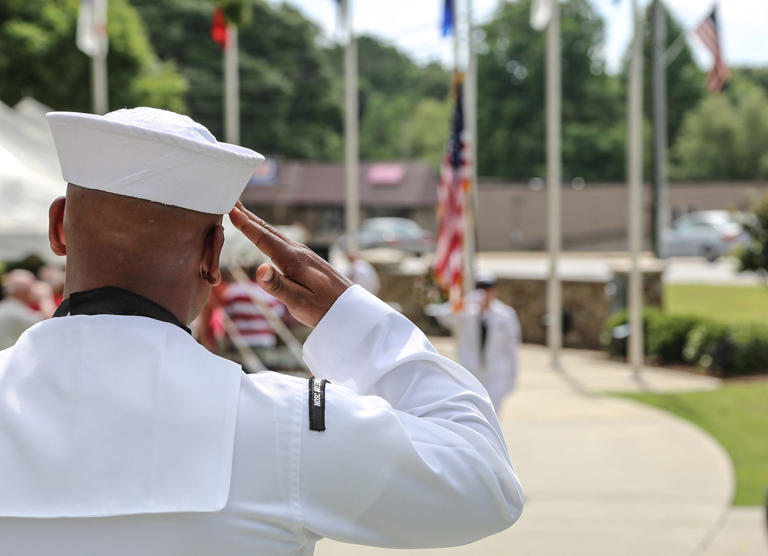 Flags fly at half-staff on Memorial Day, but not all day. Here's why