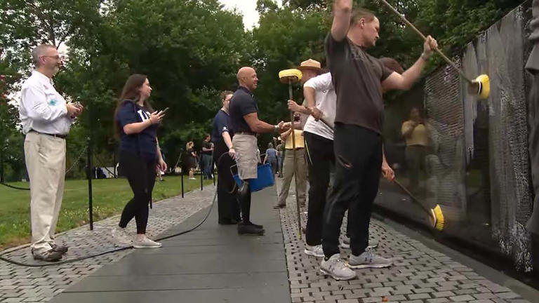 Volunteers wash Vietnam Veterans Memorial wall