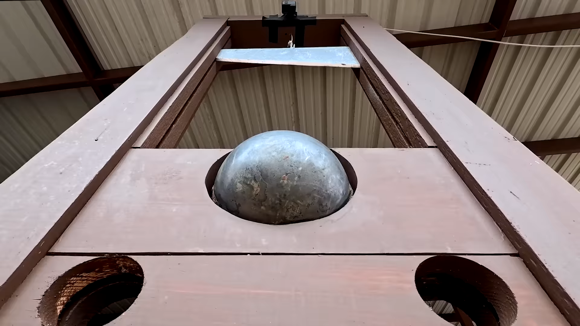 Watch grown men trying to destroy a 142 pound steel ball
