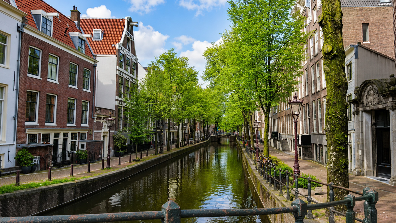Walking through Amsterdam’s historic canals in spring light