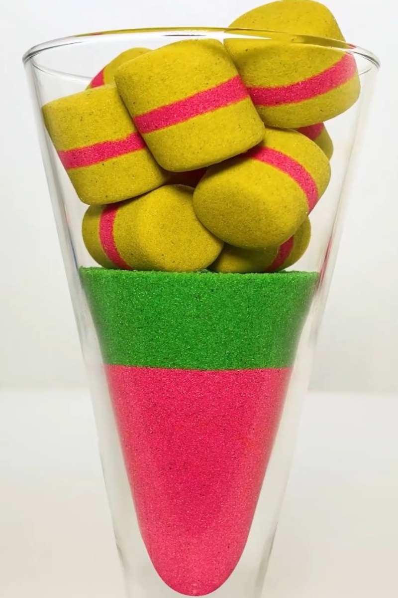 Colorful foam blocks arranged in glass with sand layers