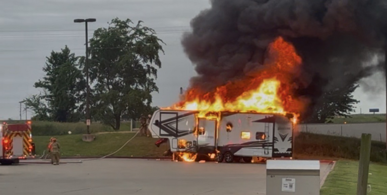 Firefighters battle camper fire
