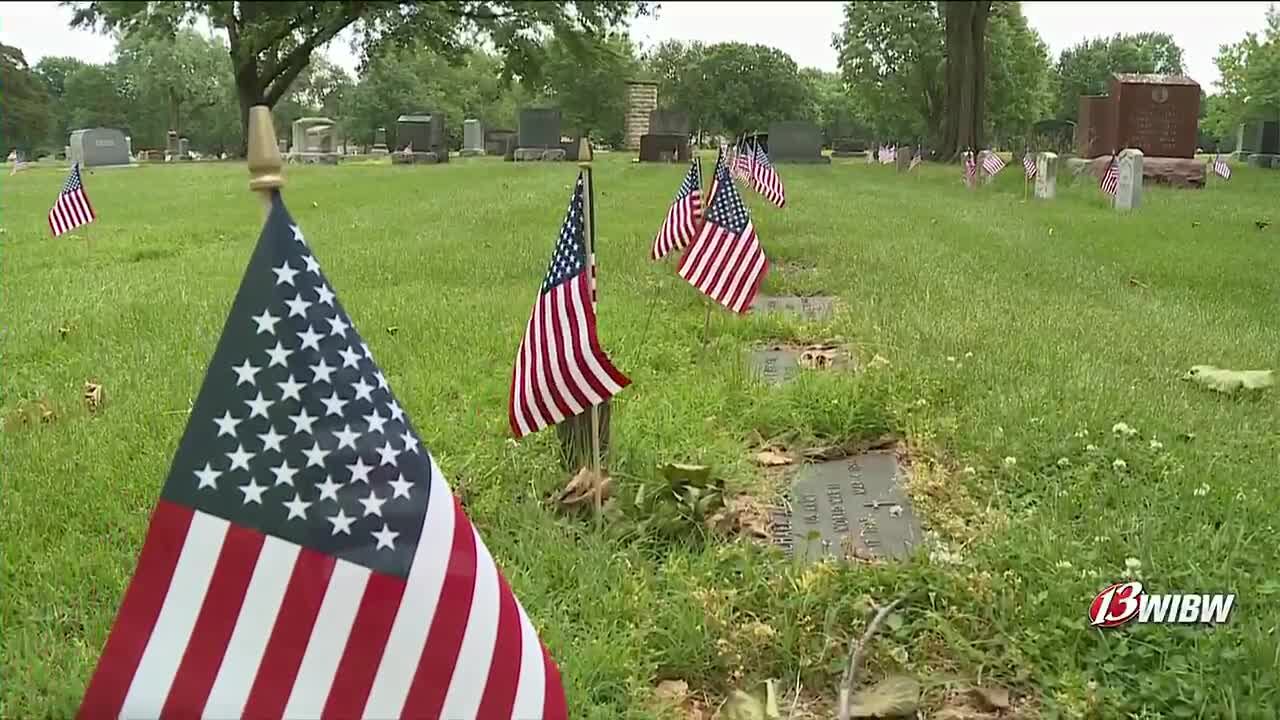 Volunteers honor veterans’ graves with flags ahead of Memorial Day
