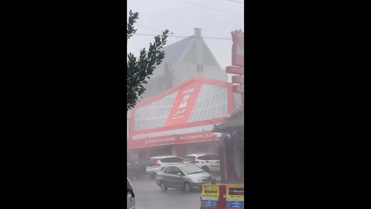 Shop sign blow over as storm lashes buildings in Indonesia