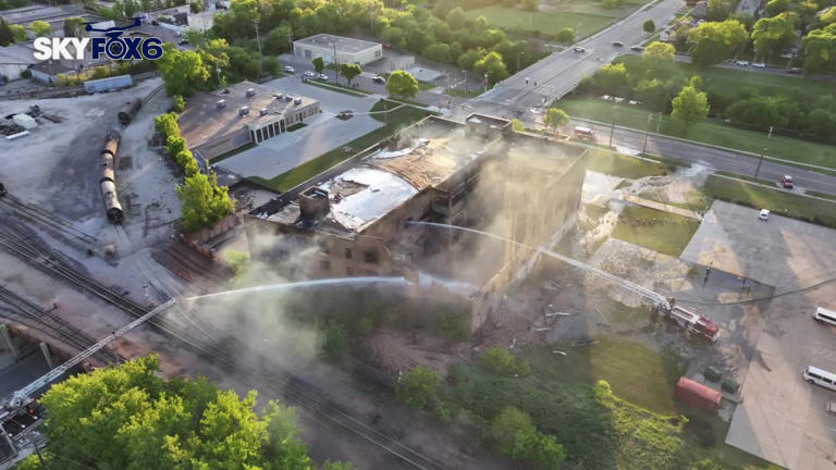 Milwaukee warehouse fire; woman arrested as raze order issued