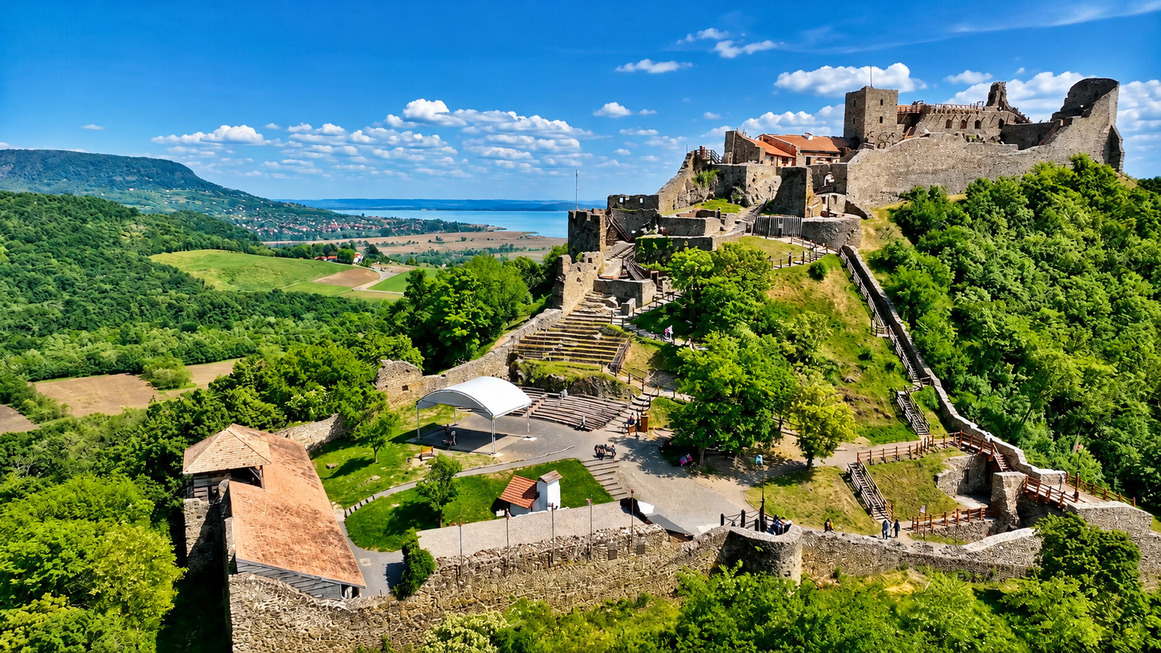 A medieval hilltop castle rising above Hungary’s rolling hills