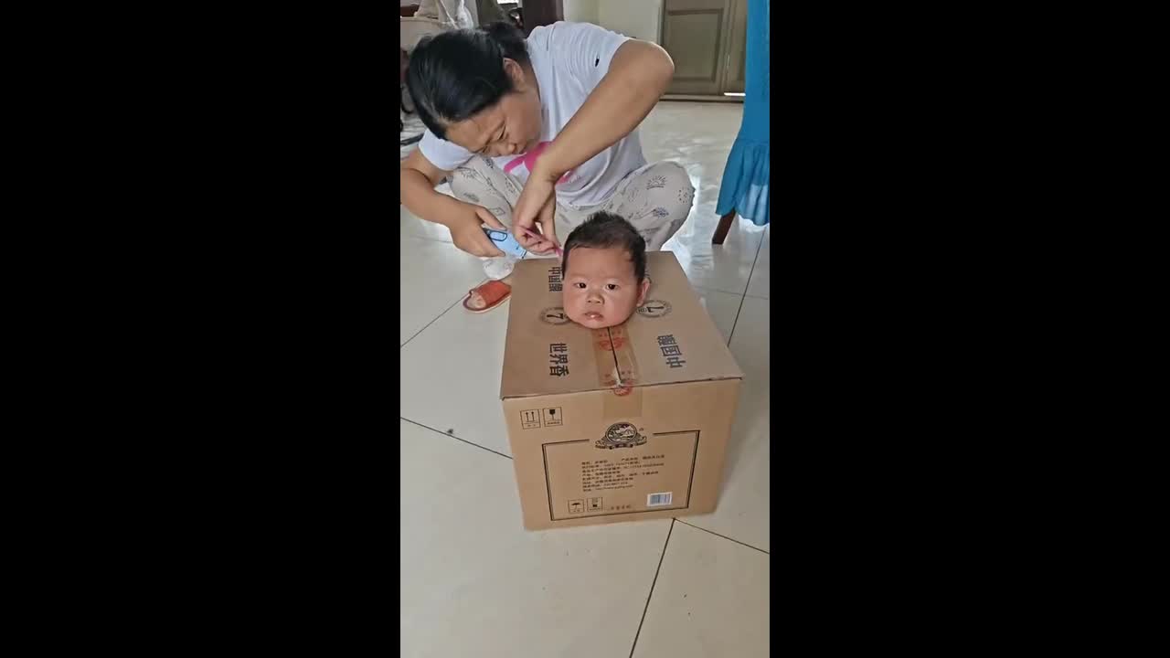 Toddler gets haircut inside a box in Jiangsu, China