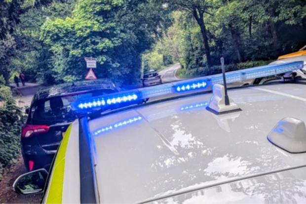 Driver fined £100 after speeding and running red light in sight of police