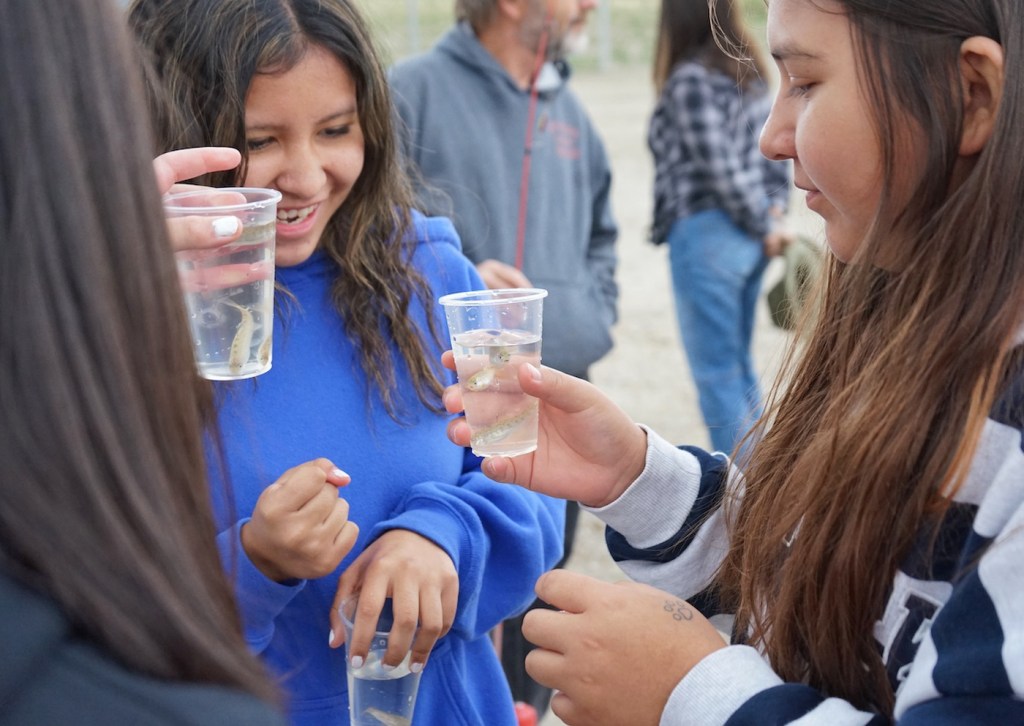 Tribal students in central Wyoming release small fish in a big pond