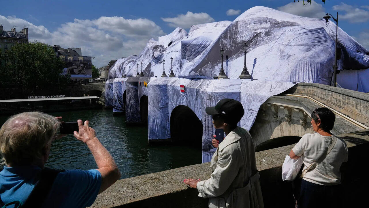 Artist JR transforms Paris' Pont Neuf with monumental cave installation