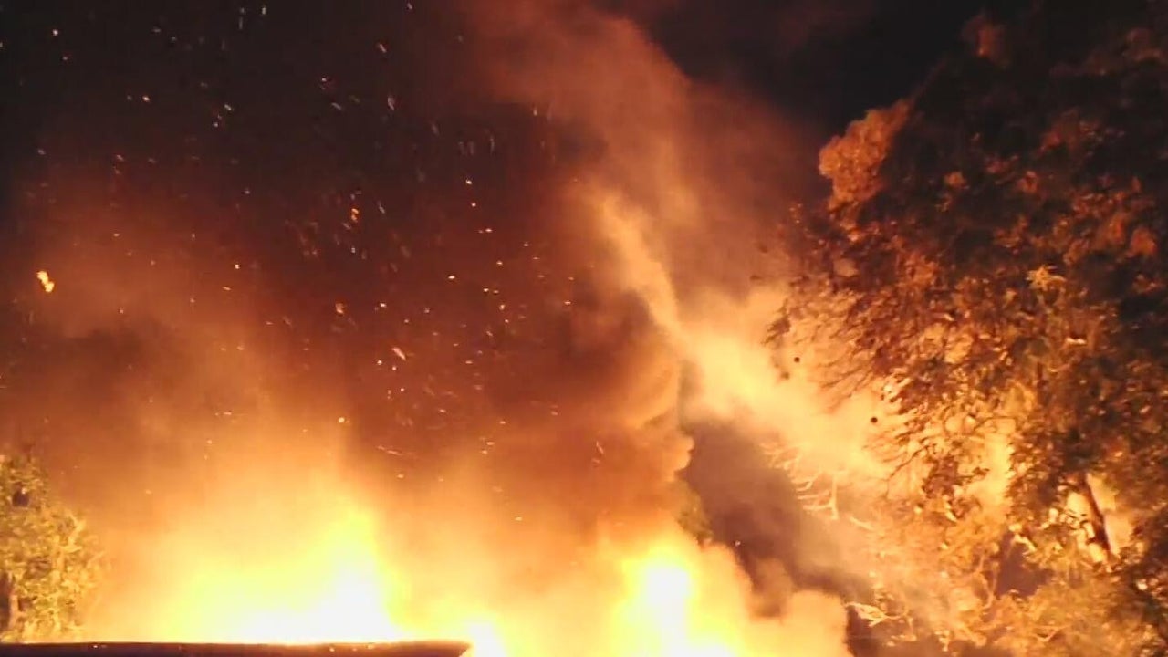 Crews race to extinguish RV, house fire in Northwest Miami-Dade