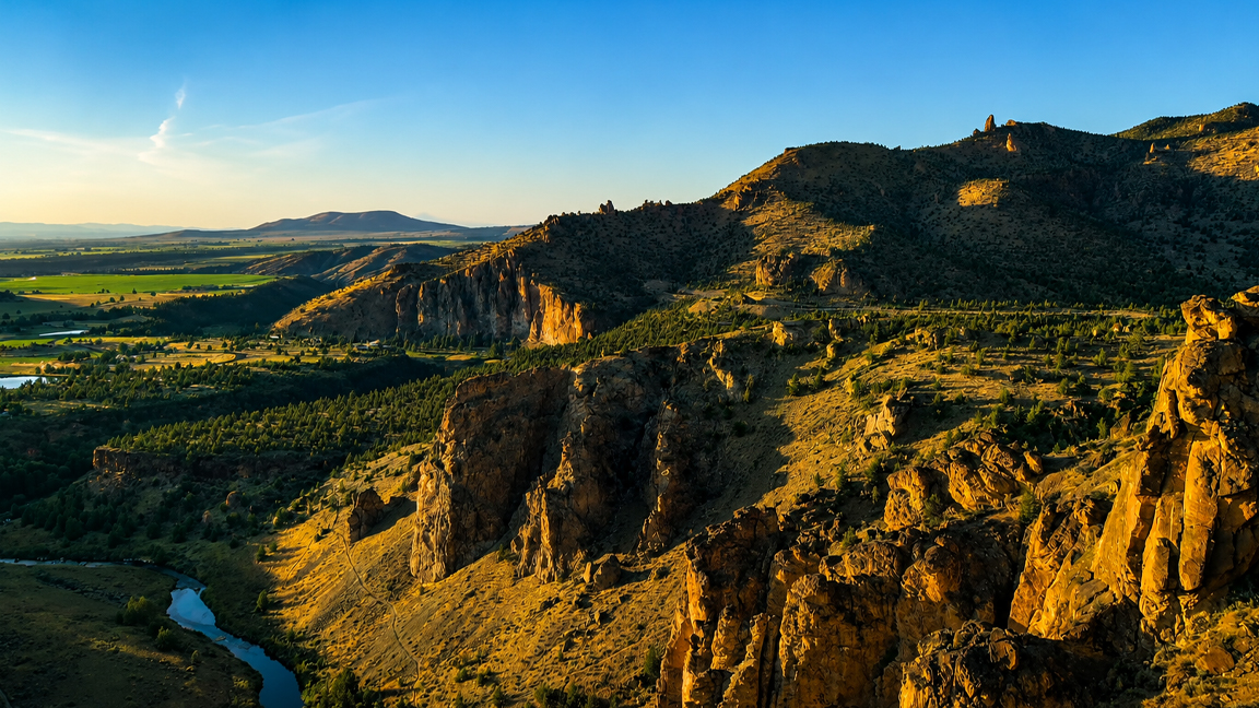 Rugged natural landscape featuring cliffs and valley river