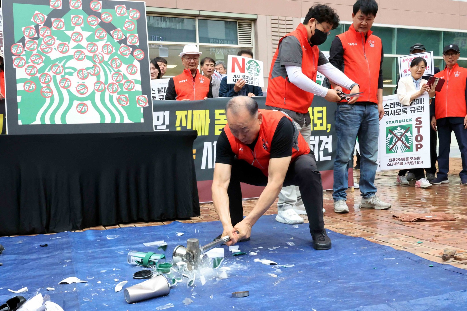 South Korean activists smash Starbucks cups to protest 'Tank Day' campaign