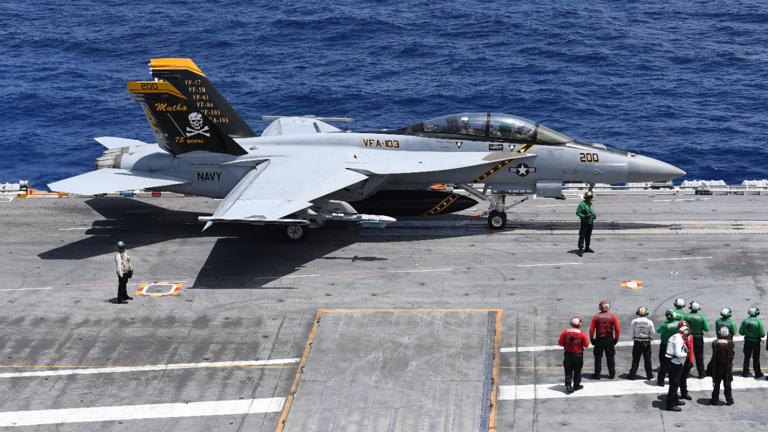 More than 20 US warships and two carrier groups are now holding the ...