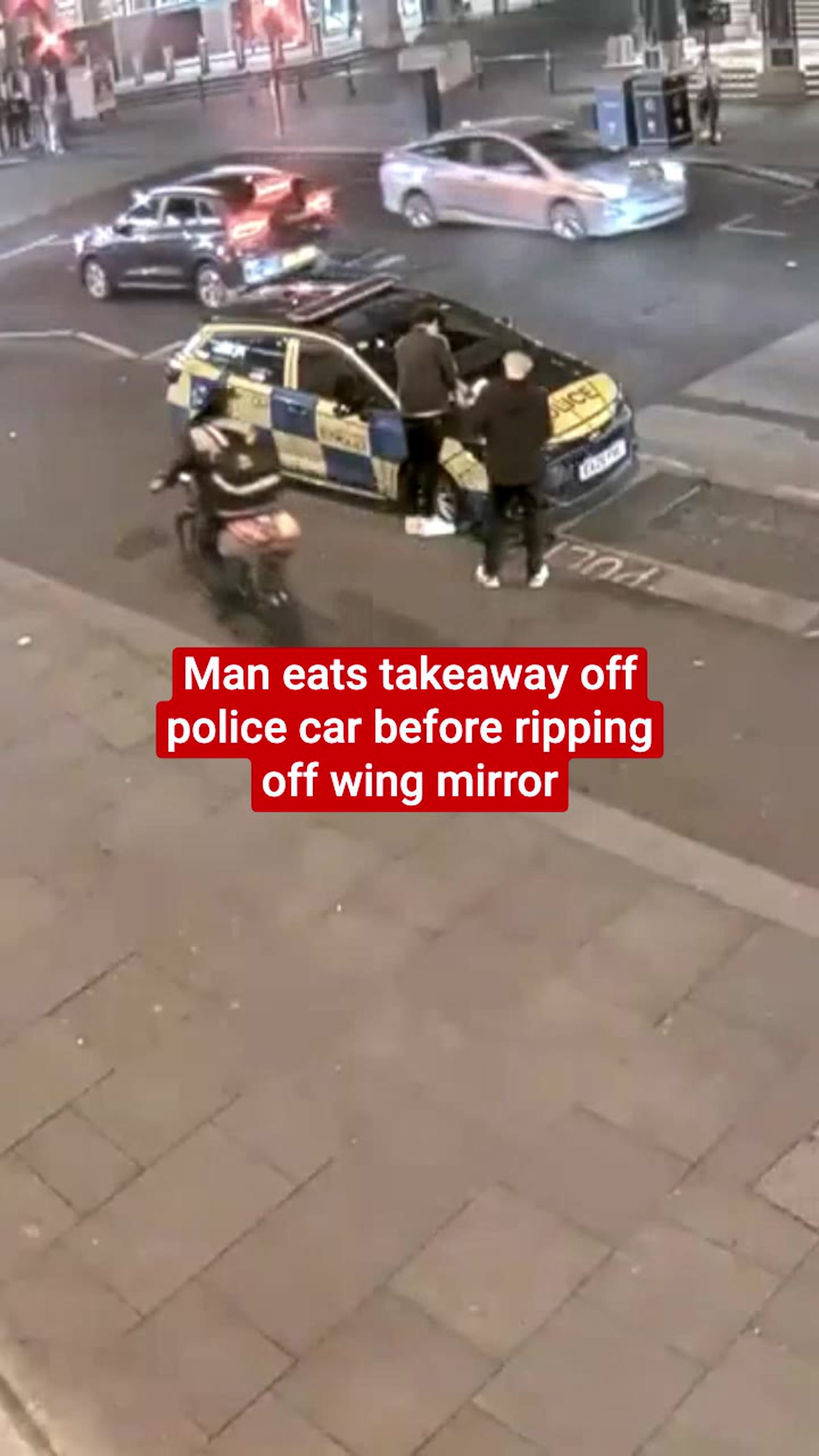 Man eats takeaway off police car before ripping off wing mirror