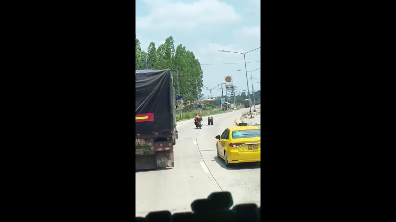 Driver shocked as runaway tire rolls on road