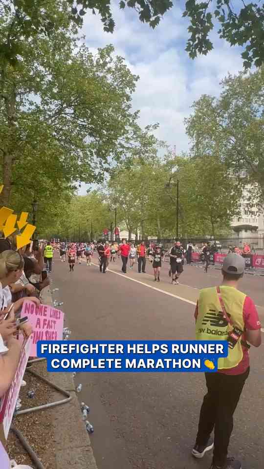 Firefighter carries exhausted marathon runner across finish line