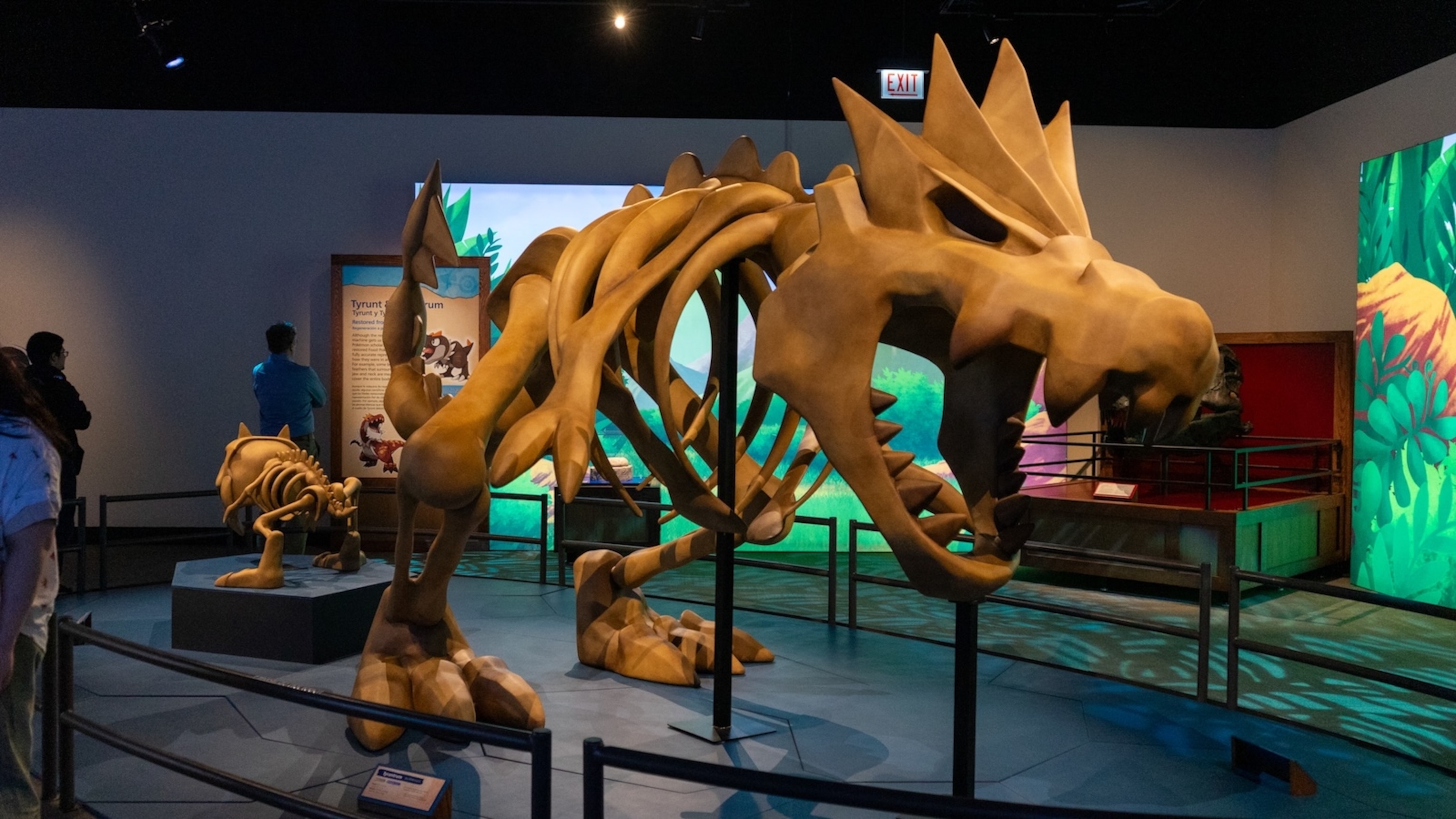 This museum exhibit features Pokémon and real fossils