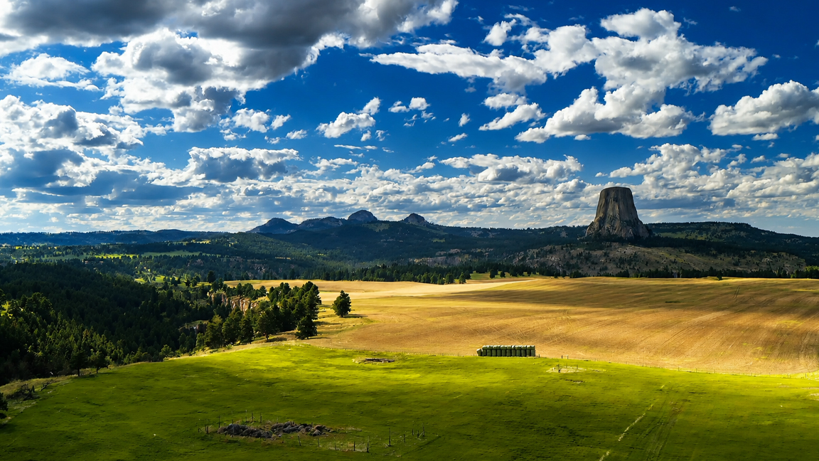 Peaceful countryside panorama featuring towering rock hill