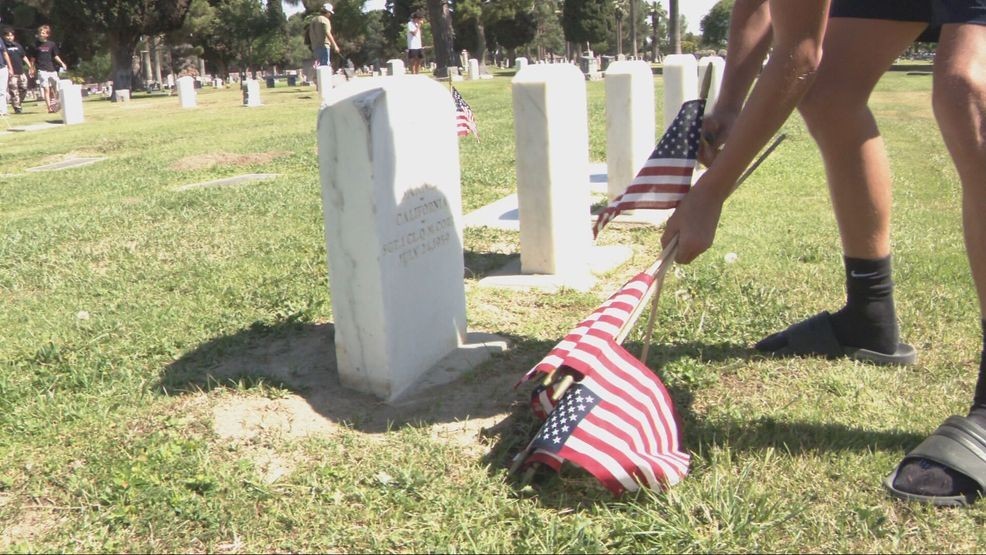 Volunteers place flags on veterans’ graves ahead of Memorial Day in ...