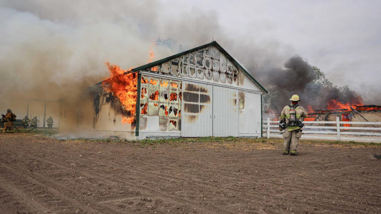 Two barns engulfed in flames in unincorporated Huntley, officials say