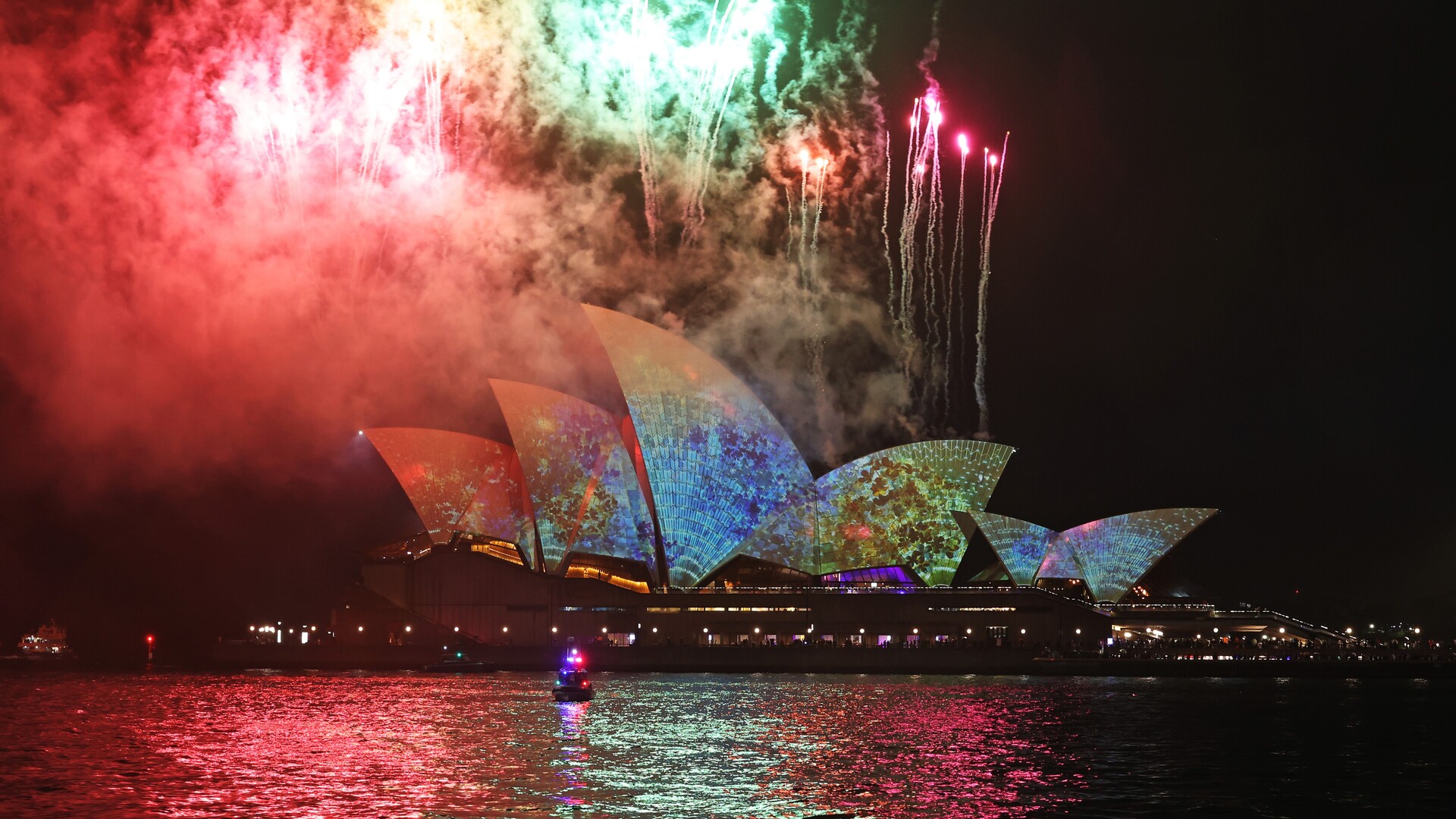 Vivid lights up Sydney Harbour despite rainy opening night