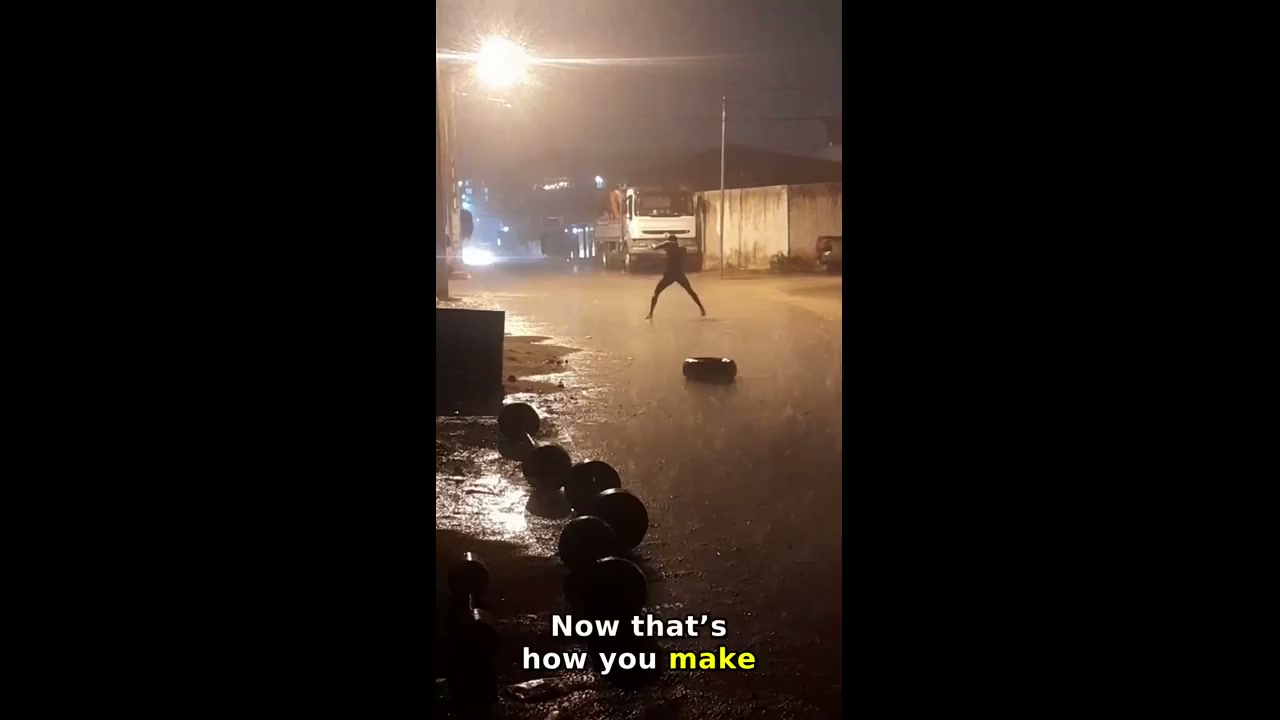 Man shadow boxes in pouring rain in France