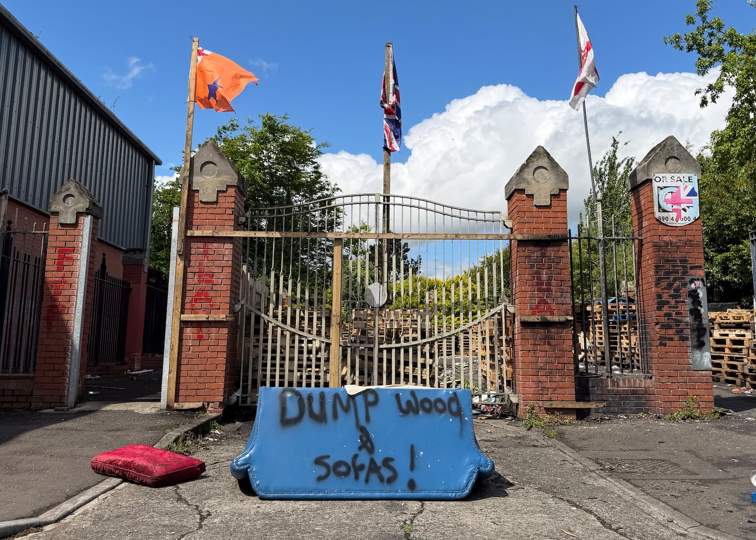 UDA and bonfire flags erected near contentious north Belfast pyre
