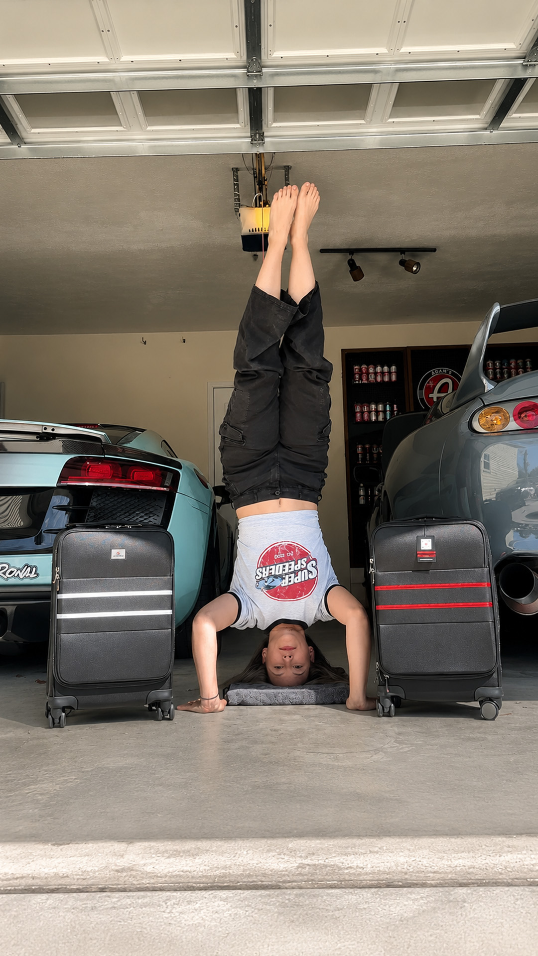 Headstand challenge between two sports cars