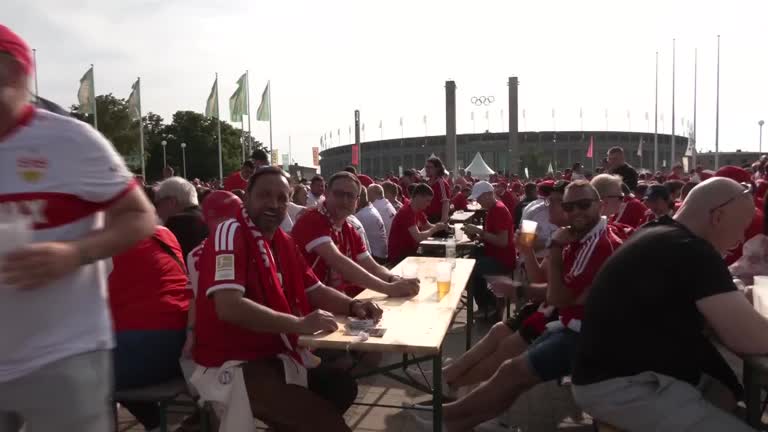 Cheerful, jubilant soccer fans arrive at Berlin’s Olympic Stadium for ...