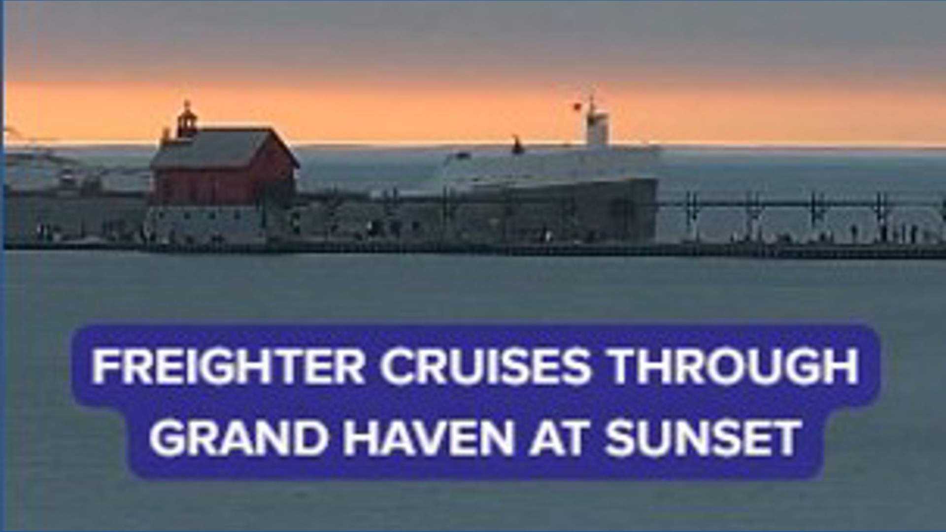Freighter cruises through Grand Haven at sunset