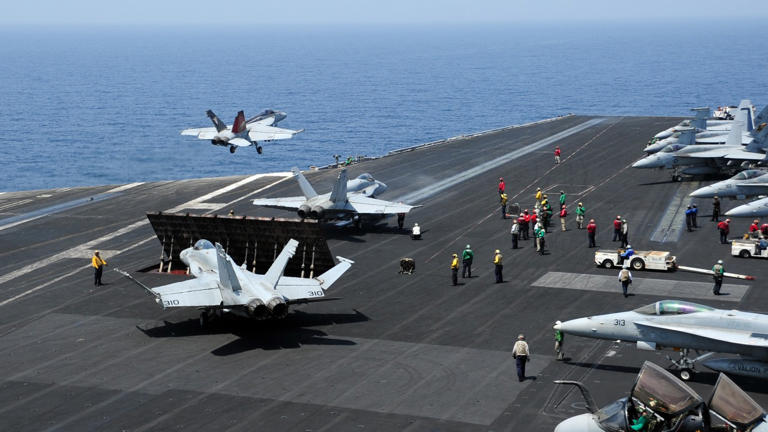 More than 20 US warships and two carrier groups are still holding the ...