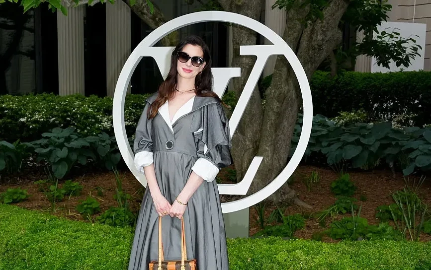 Anne Hathaway embraces overdressed trend at Louis Vuitton show