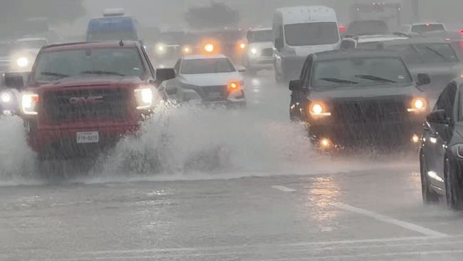 Drivers push through flooded road in Houston suburbs