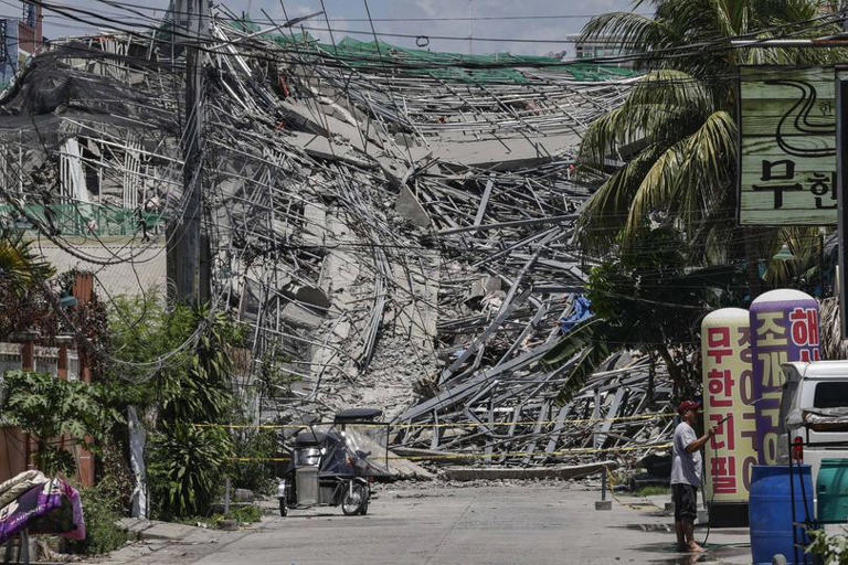 21 missing after nine-story building collapses as 'voices' heard ...