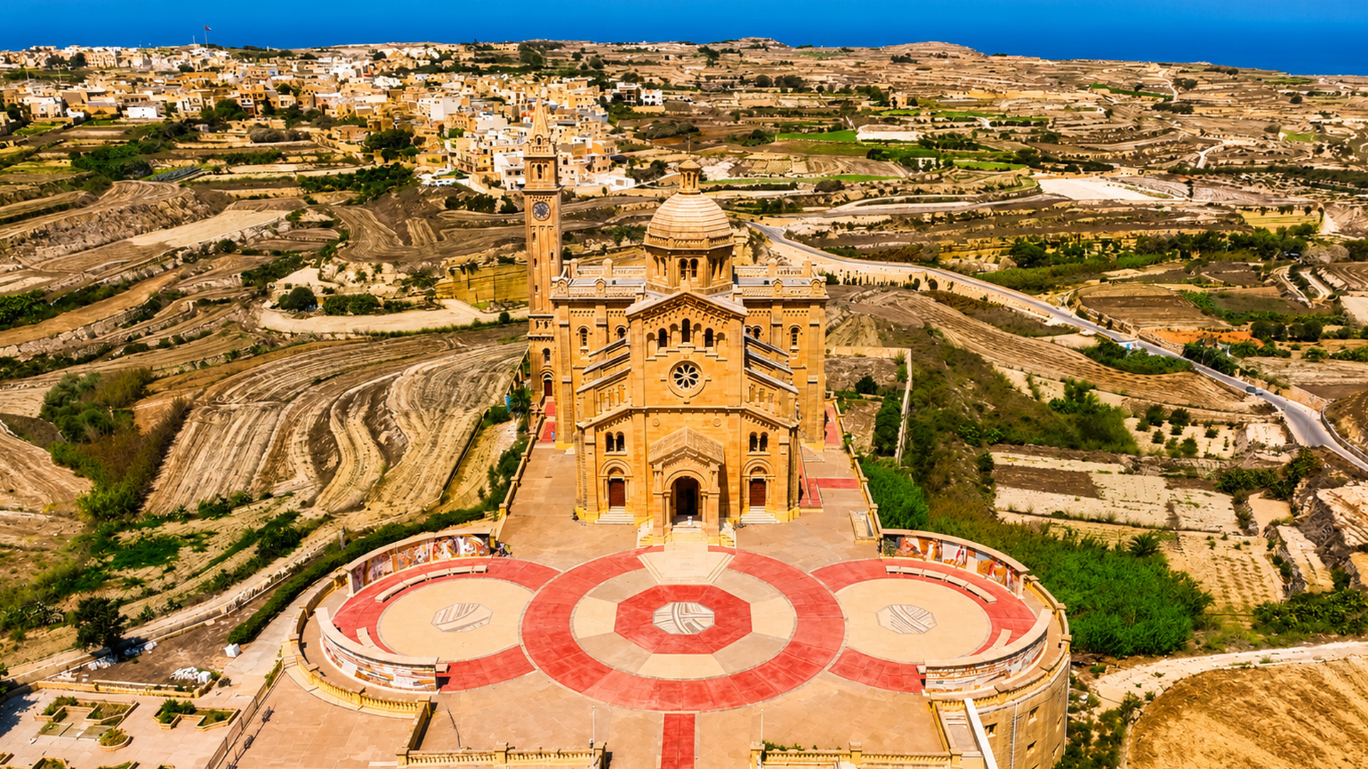 A massive church surrounded by dry empty land