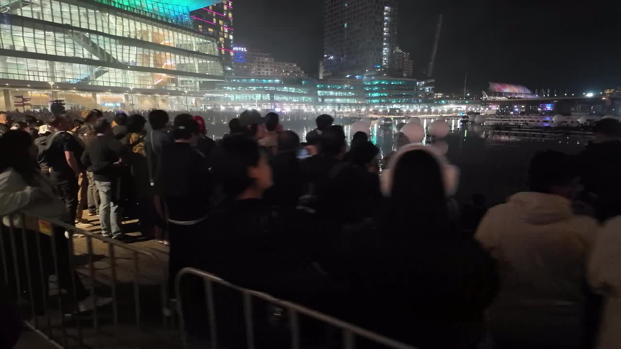 Crowds gather ahead of the 9:30pm Vivid Sydney drone show in Sydney ...