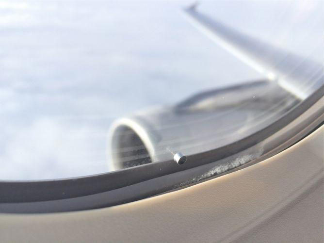 That small hole at the bottom of airplane windows: What it’s for and ...